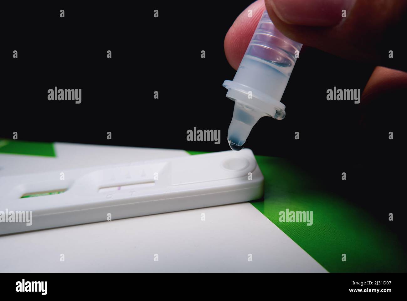 Own hand placing the droplet secretions sample into the SARS CoV-2 ...