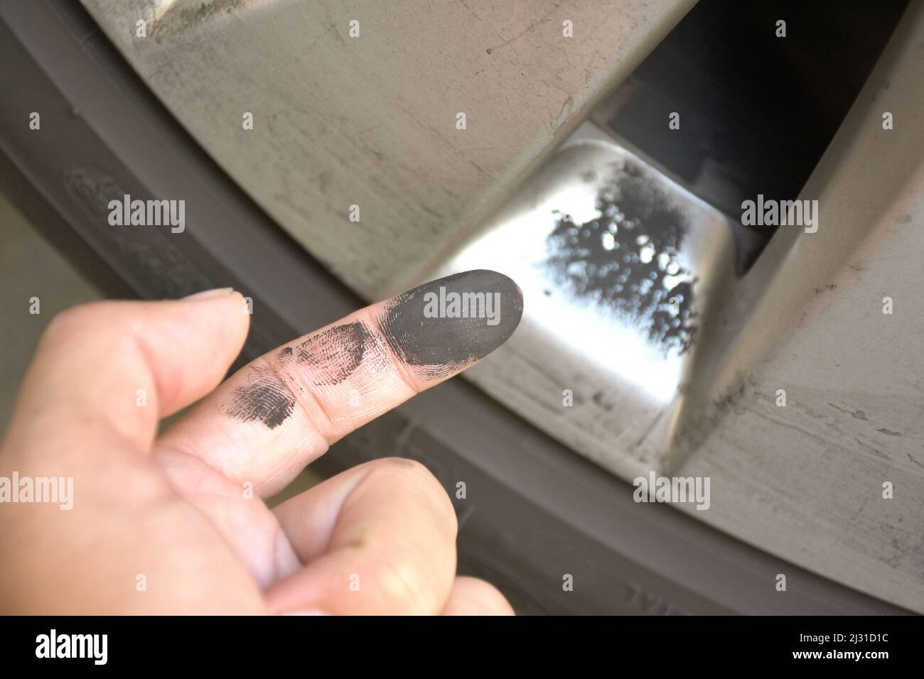Brake dust of the brake pads on the mechanic finger and the rim Stock ...