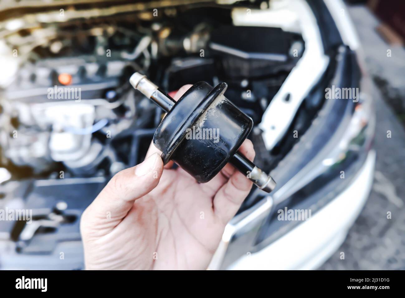 Old gear oil filter of the car transmission system on the mechanic hand ...