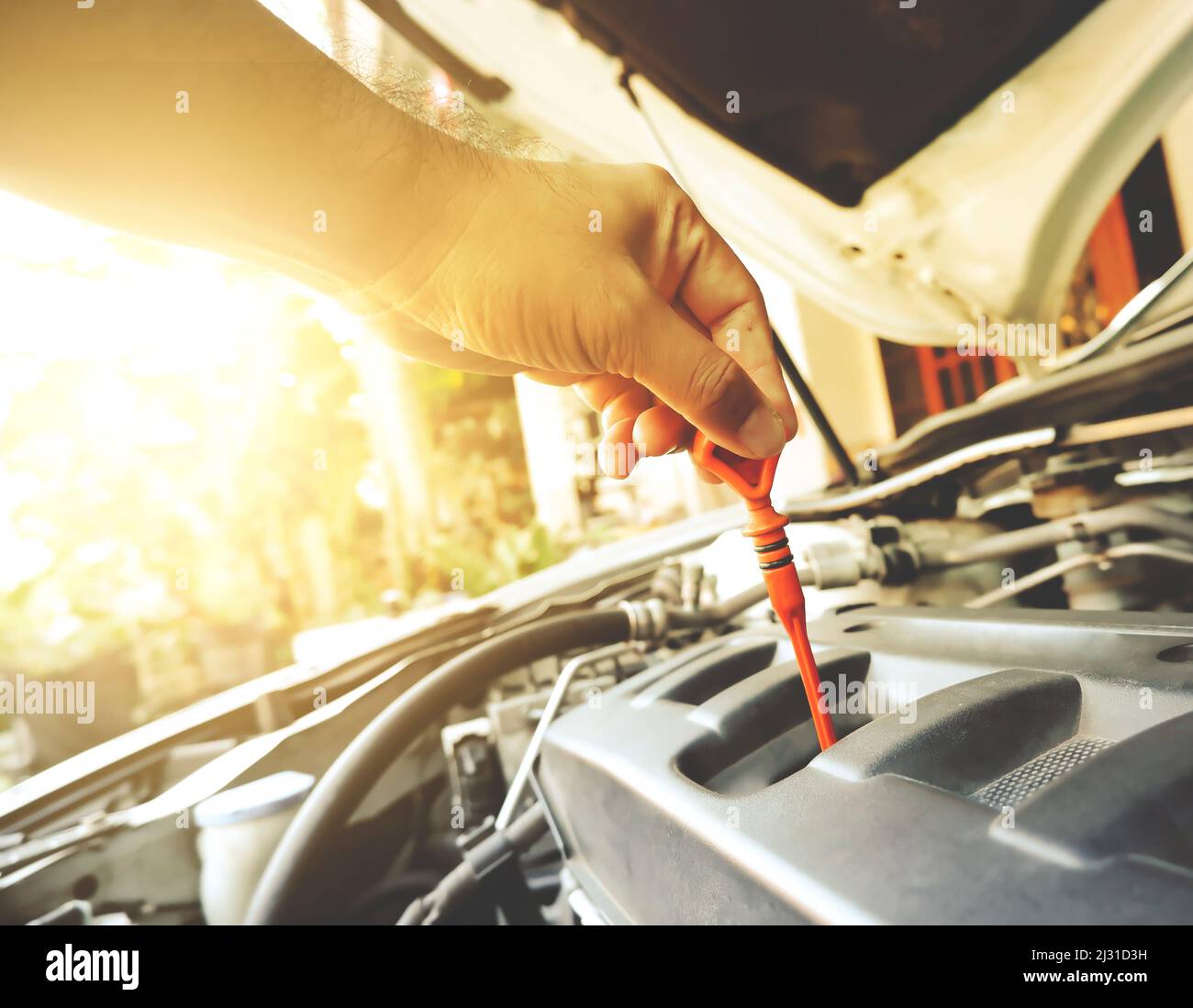 Mechanic hand was pulling oil dipstick to lube level checking of engine ...