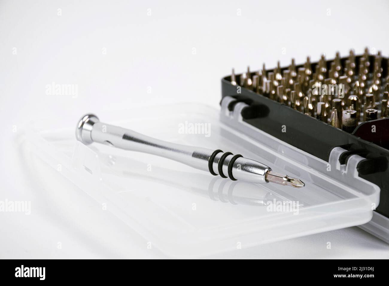 Multi precision ratchet screwdriver set in the plastic box on white ...