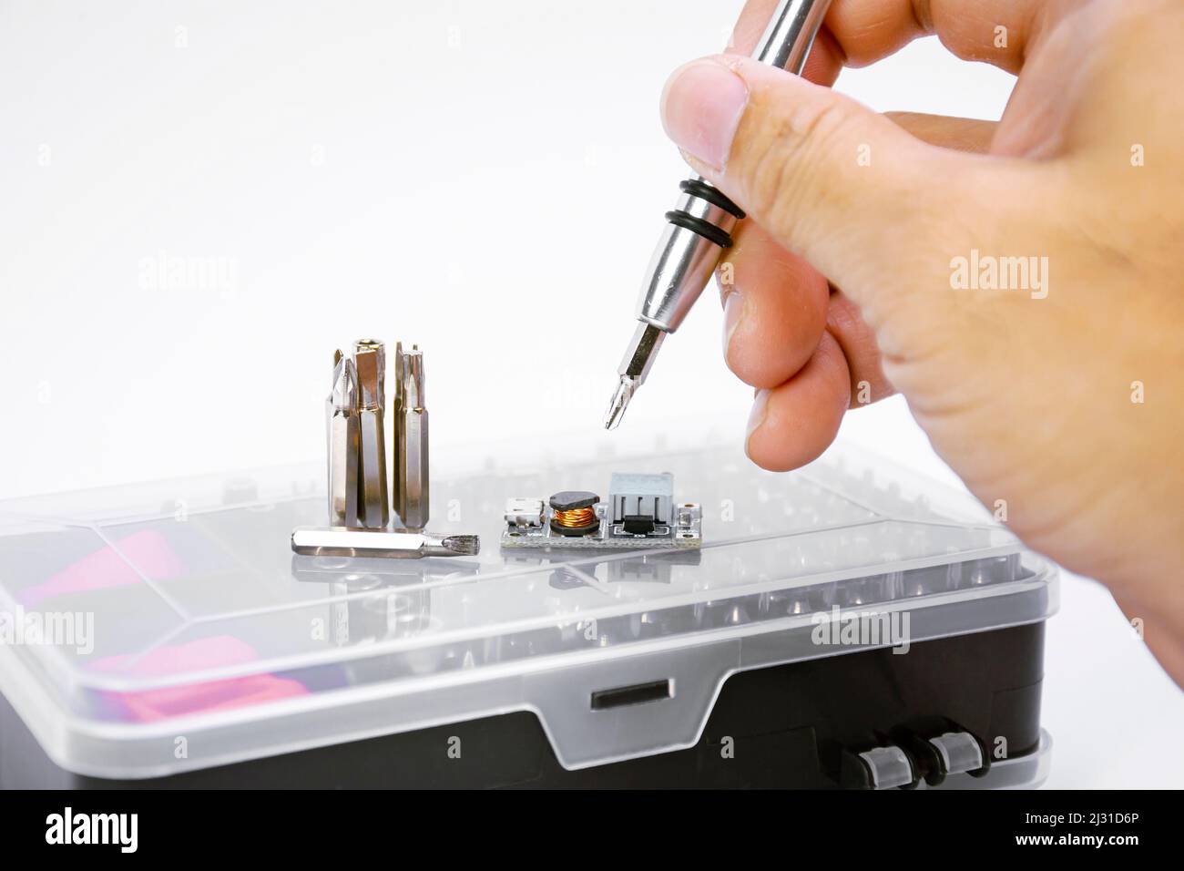 Electronic technician removing metal nut with a multi precision ...