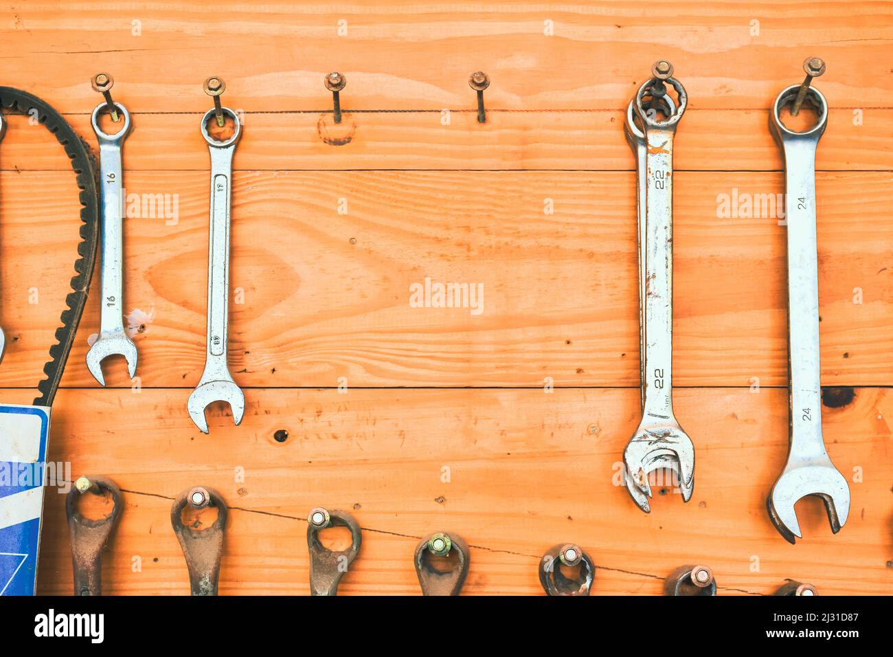 Auto mechanic tools pegboard on the wooden wall mount with copy space ...
