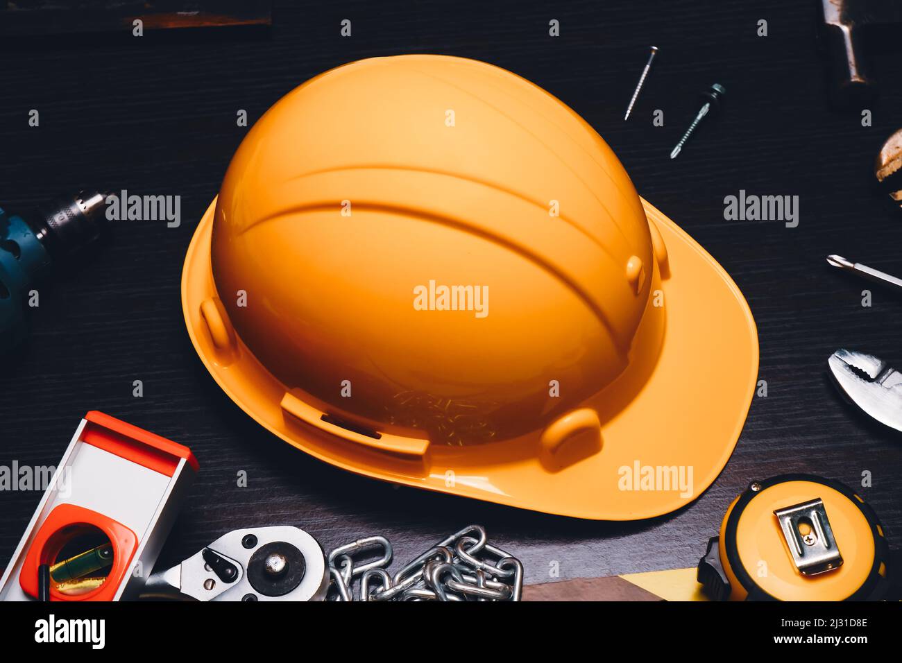 Safety helmet, hard hat with yellow color on the wooden table and ...