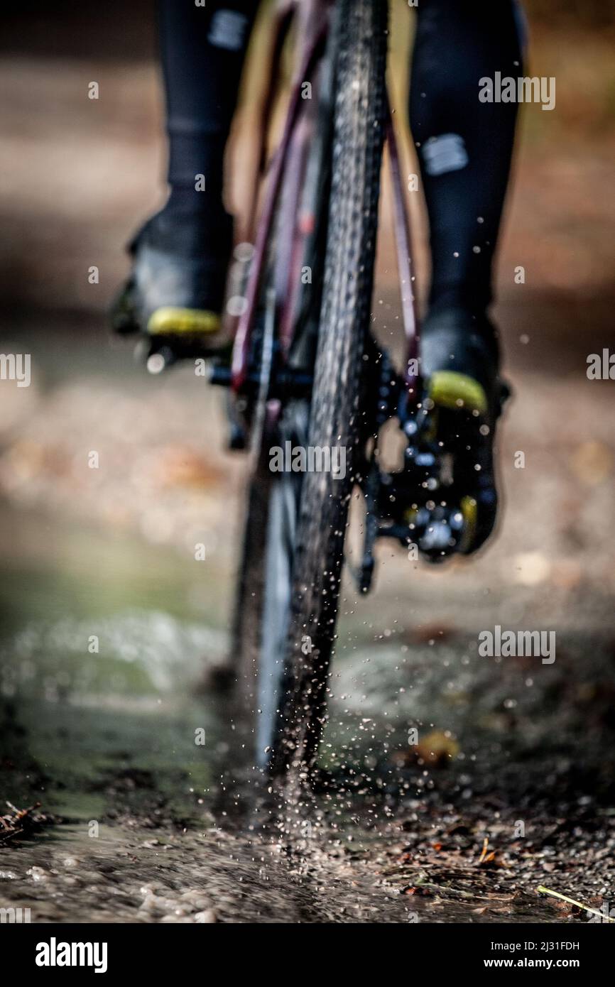 Cycling through puddle hi-res stock photography and images - Alamy