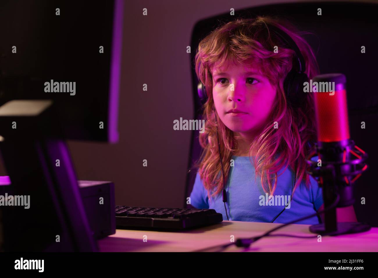 Child plays a video game on the pc computer screen. School, study ...