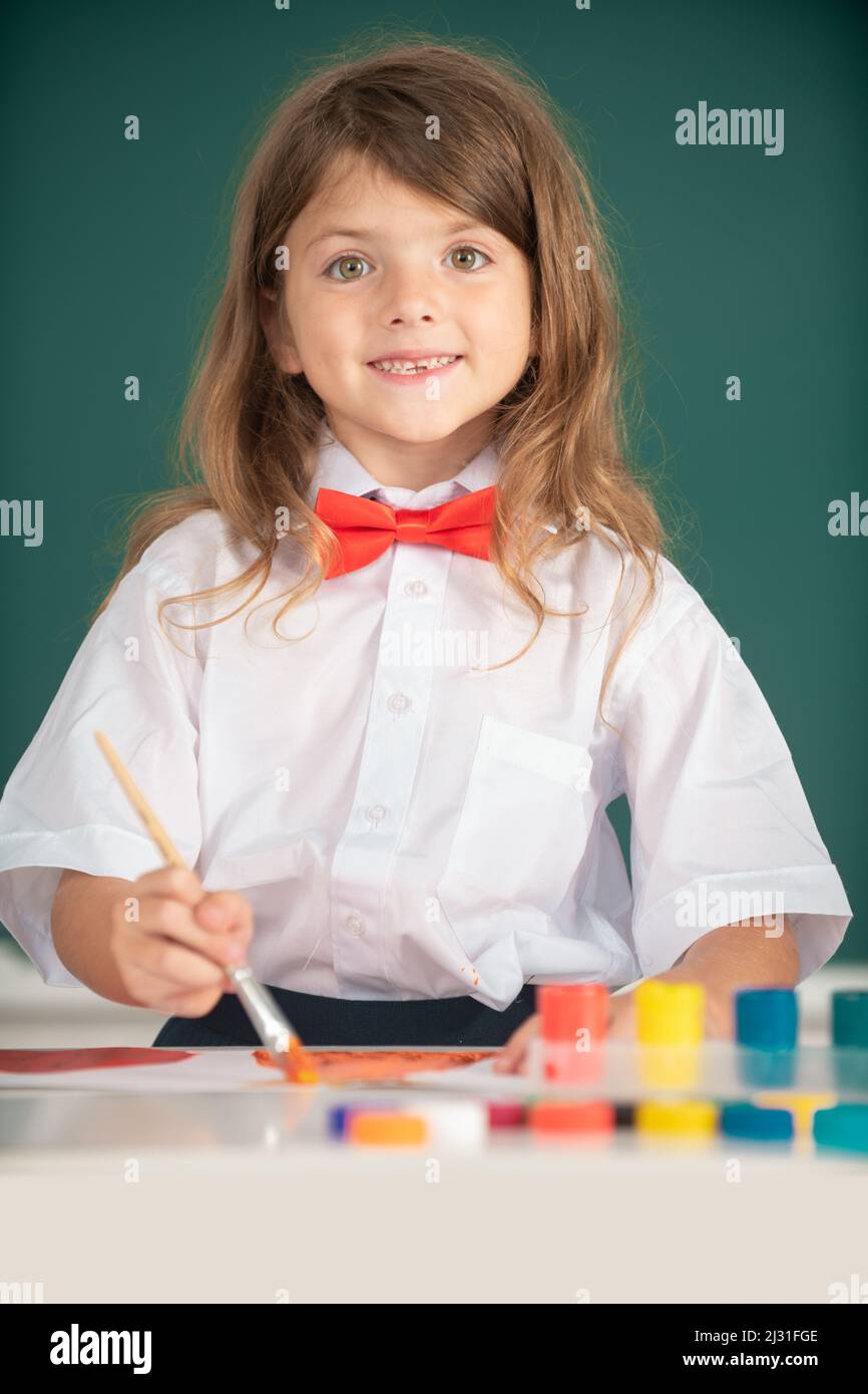 Cute little girl child painting with paints color and brush. Drawing ...
