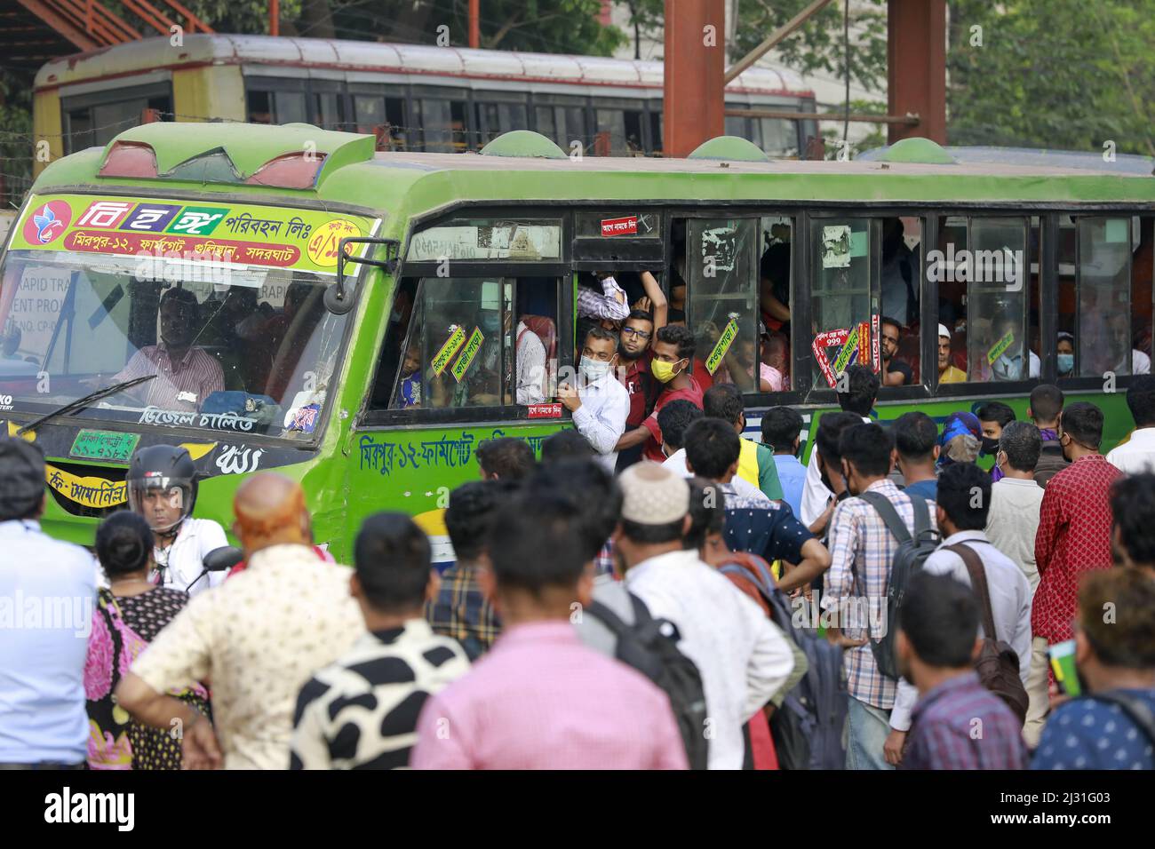 Bangladeshi people ride in an overcrowded bus to travel home ahead of ...