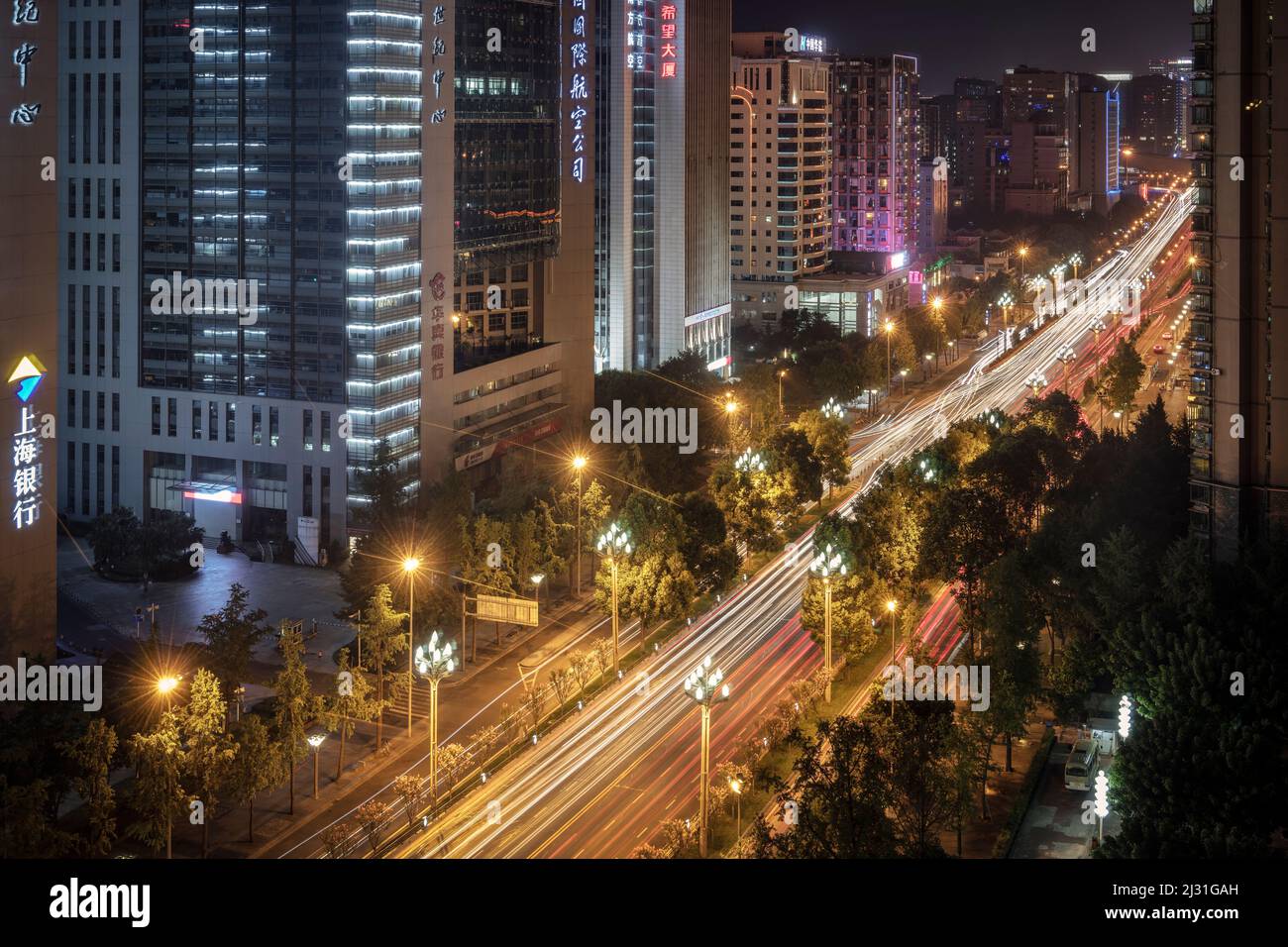 Traffic and skyscrapers in Chengdu at night, Sichuan Province, China ...