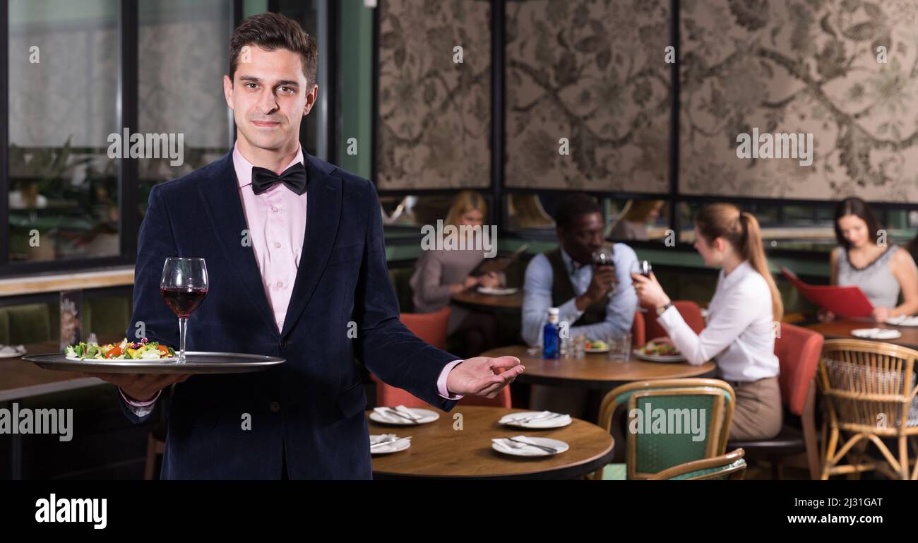 Elegant waiter with serving tray Stock Photo - Alamy
