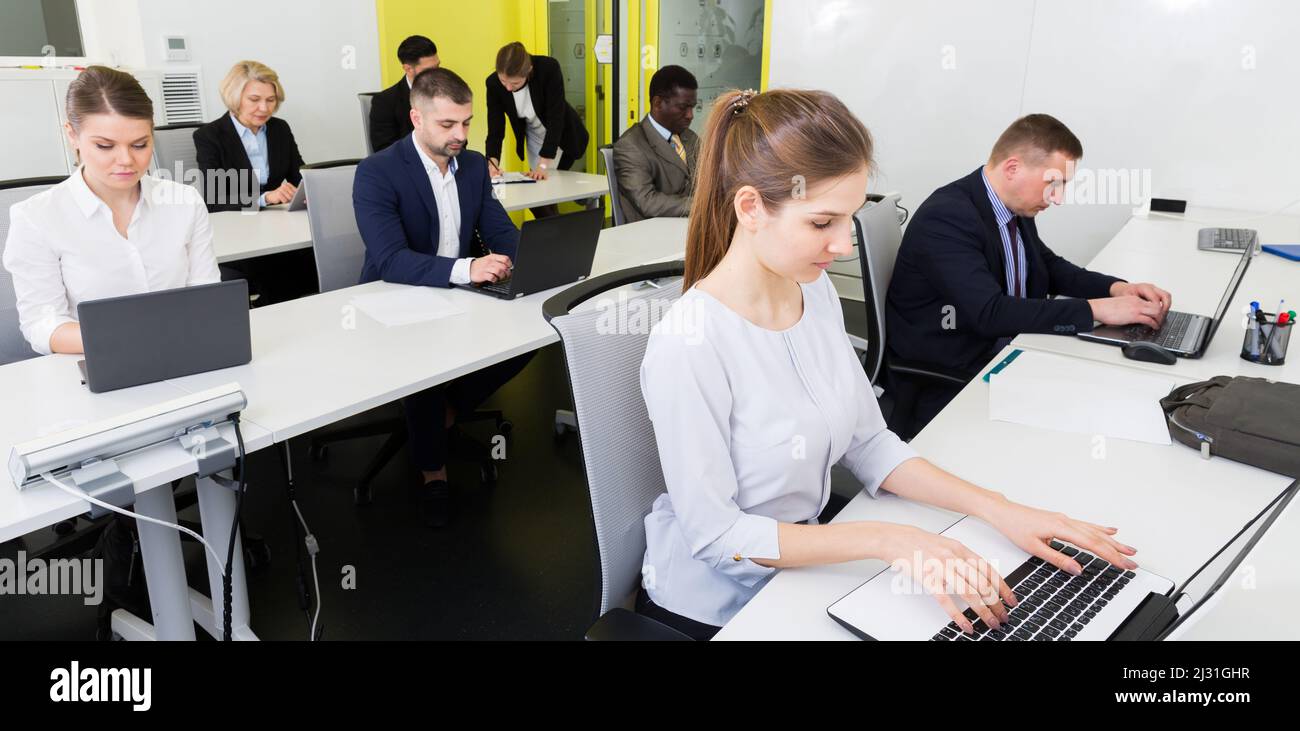 Business people working in open plan office Stock Photo - Alamy