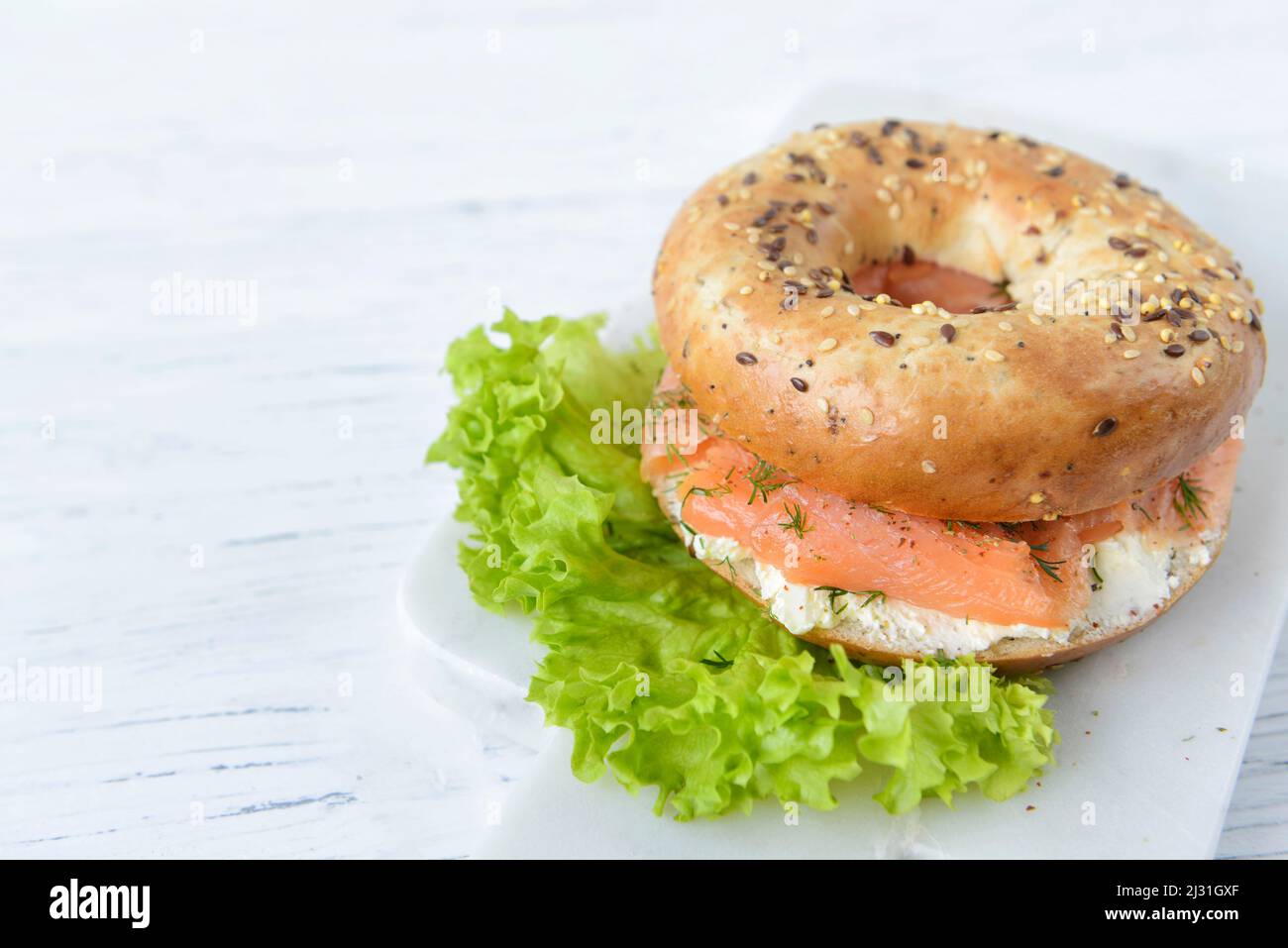 Fresh multigrain bagel bun with cream cheese, smoked salmon slices ...