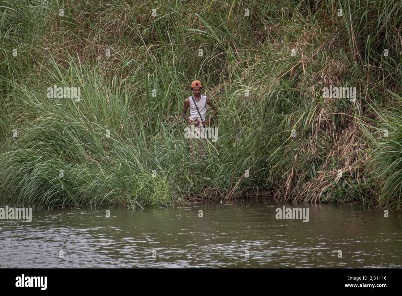 Karen refugee man seen fishing on the Myanmar side of the Moei River ...
