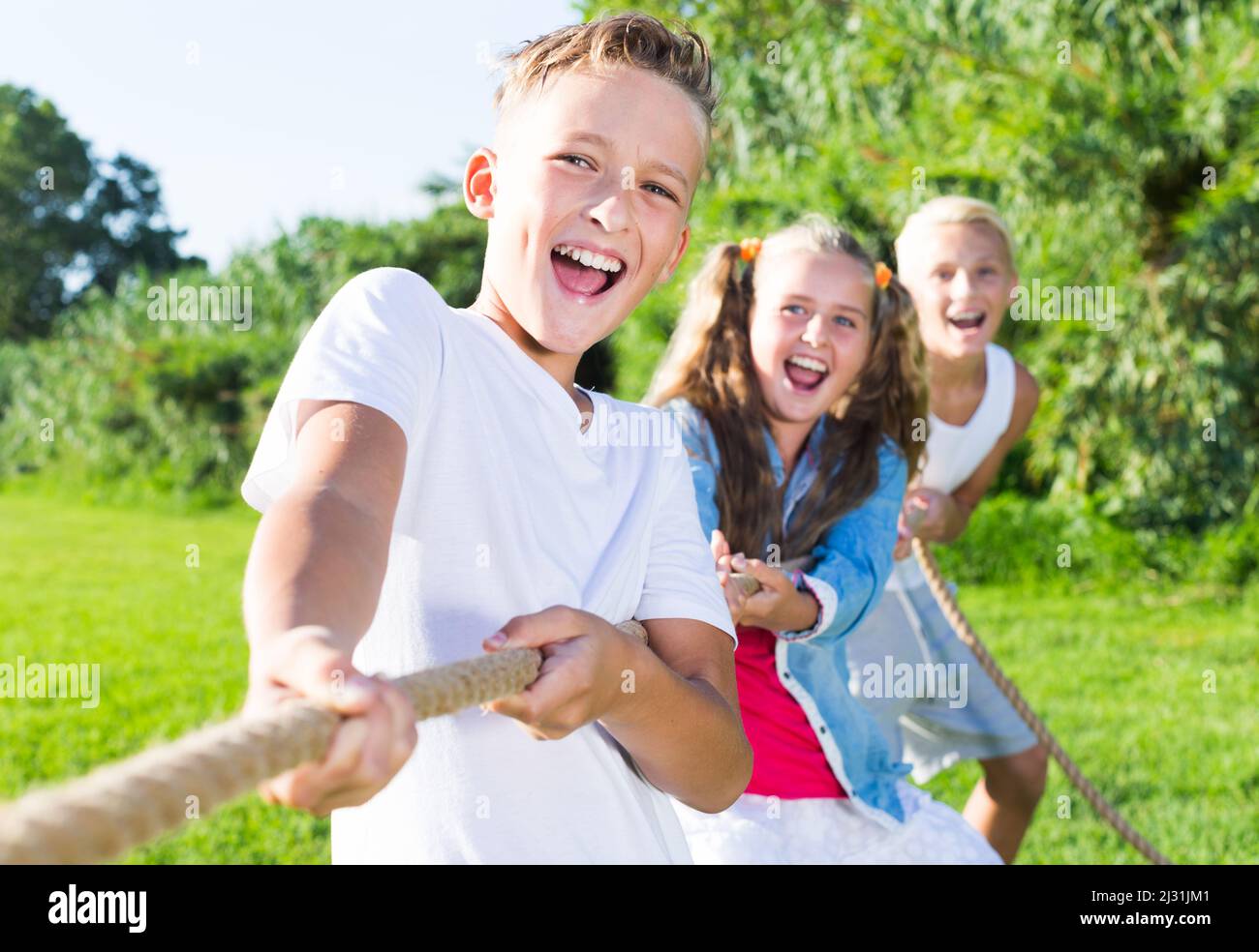 Children pulling rope outdoors Stock Photo - Alamy