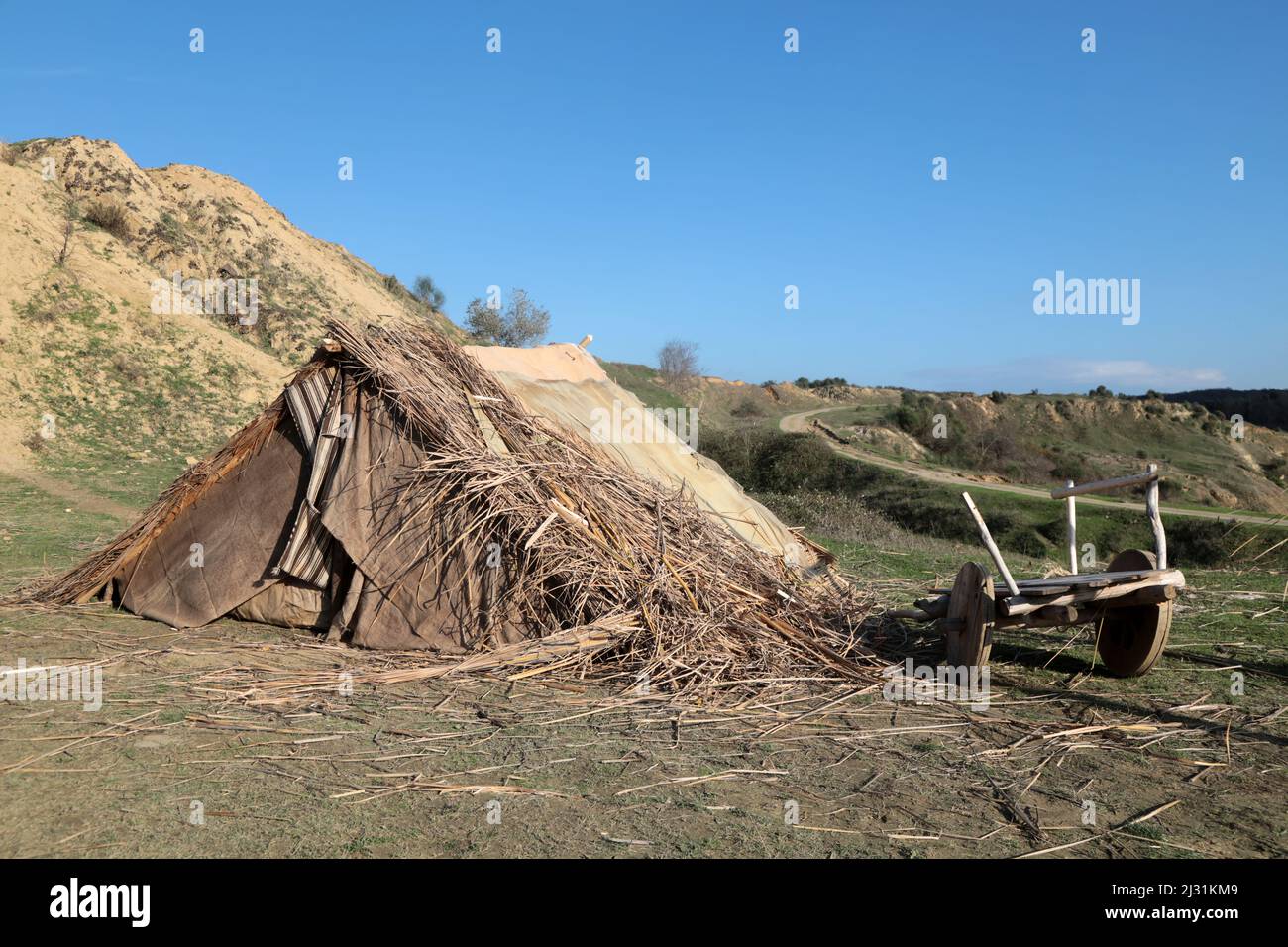 A reed tent on a mountain slope. There are old furniture and fire in ...