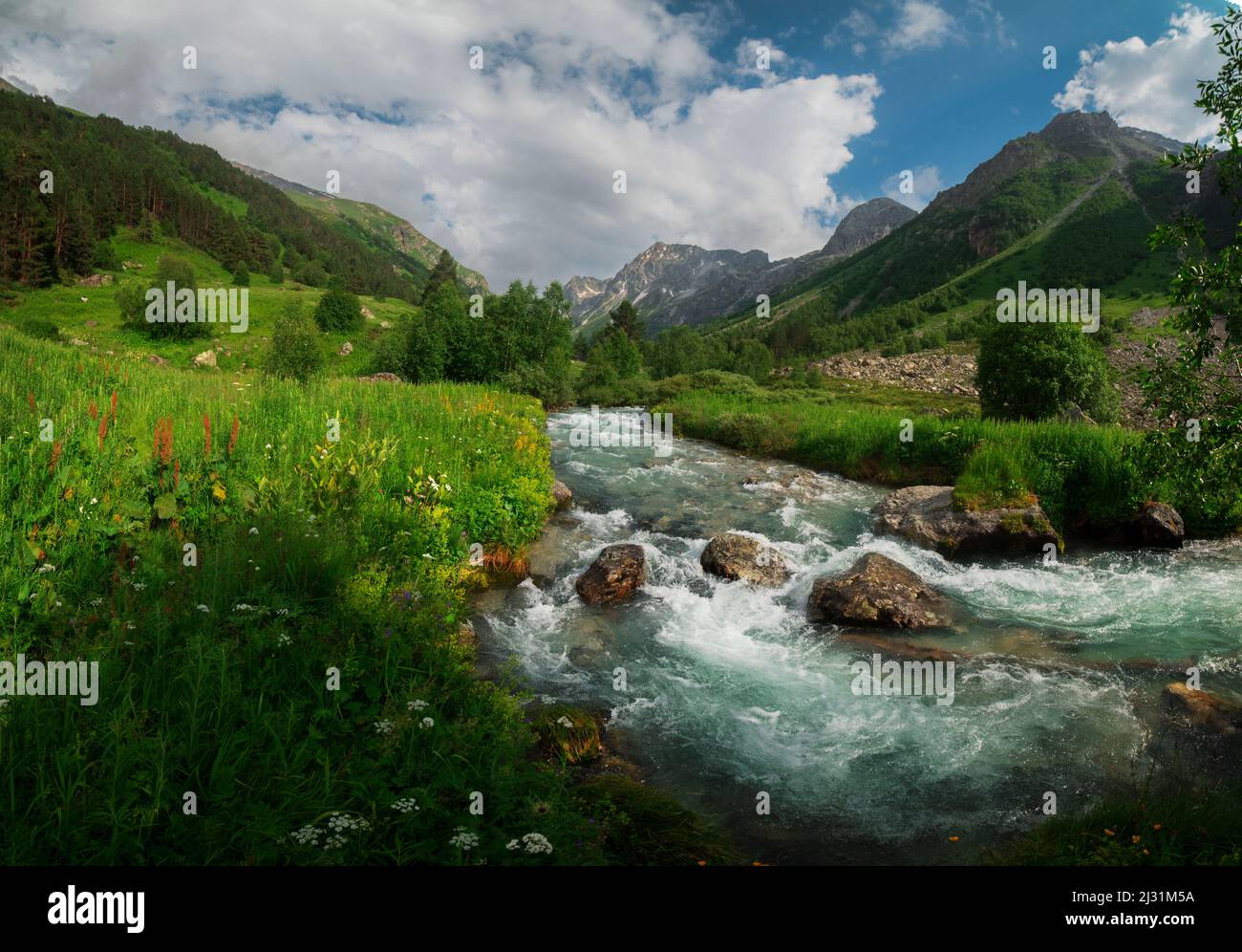 A high-mountain river with clear water flows in a picturesque mountain ...