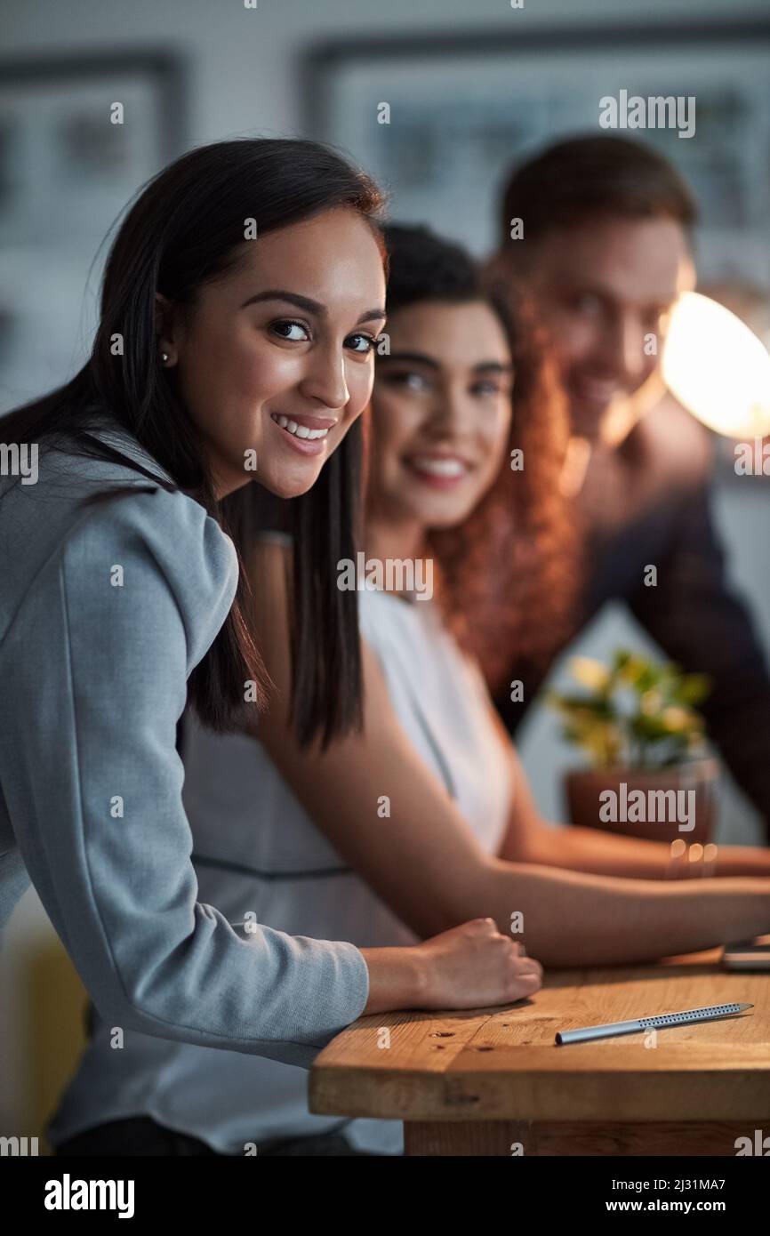 We push each other to achieve more. Portrait of three colleagues ...