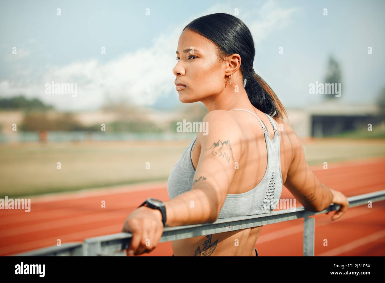 Taking a break. Cropped shot of an attractive young female athlete ...