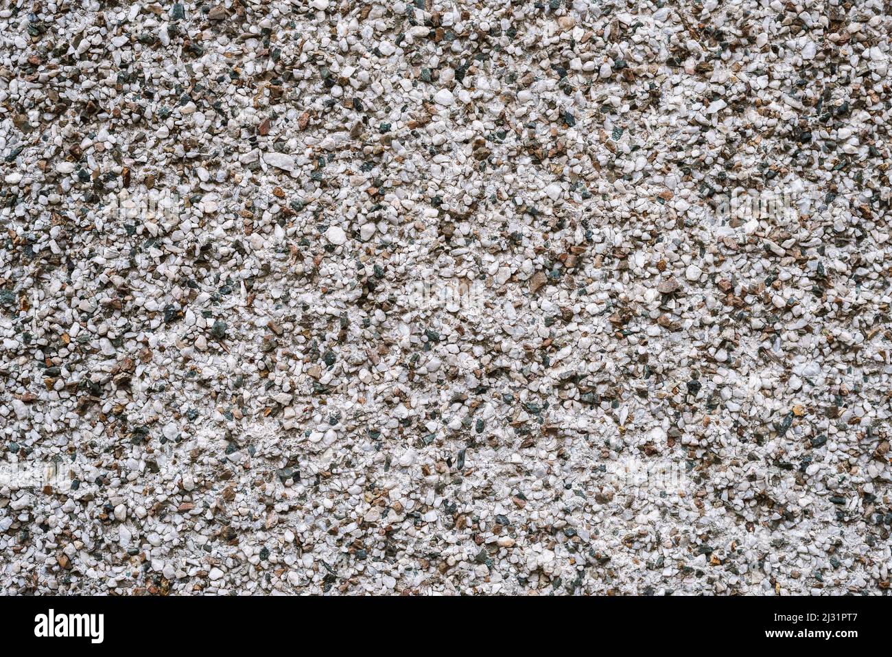 Wall with small stones as texture background Stock Photo - Alamy