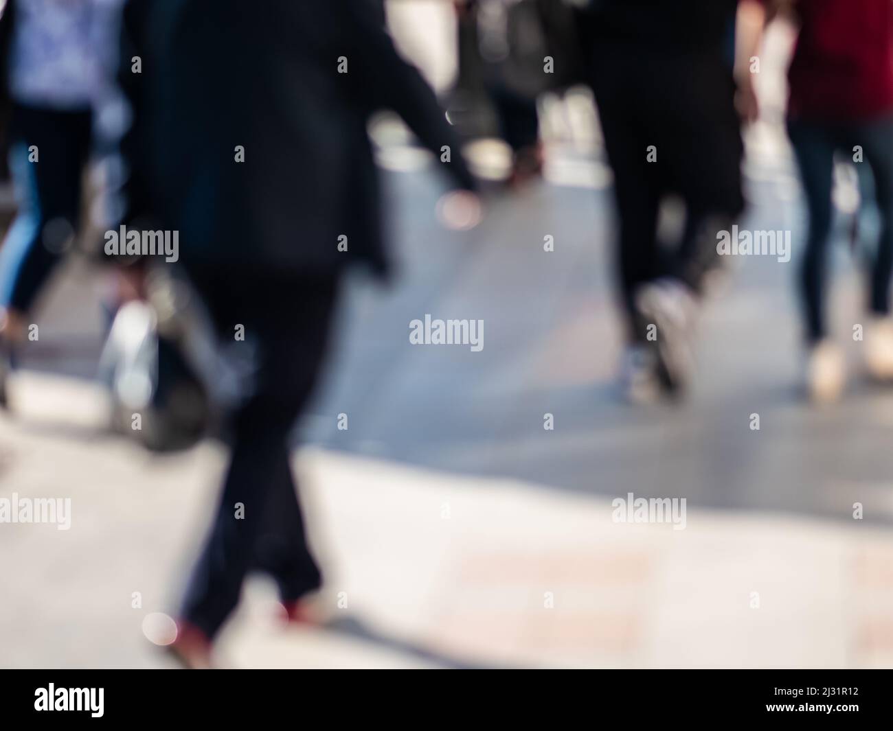 Out of focus background with people crossing street Stock Photo - Alamy