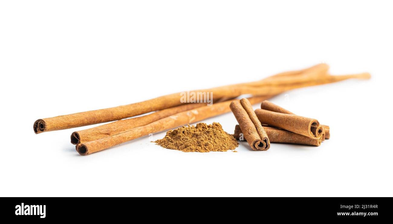 Dry cinnamon sticks and cinnamon powder isolated on a white background ...