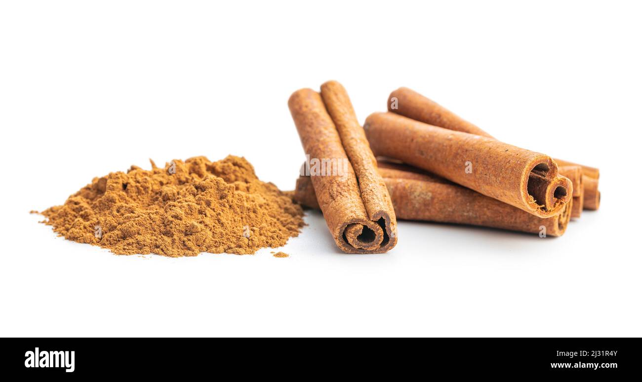 Dry cinnamon sticks and cinnamon powder isolated on a white background ...