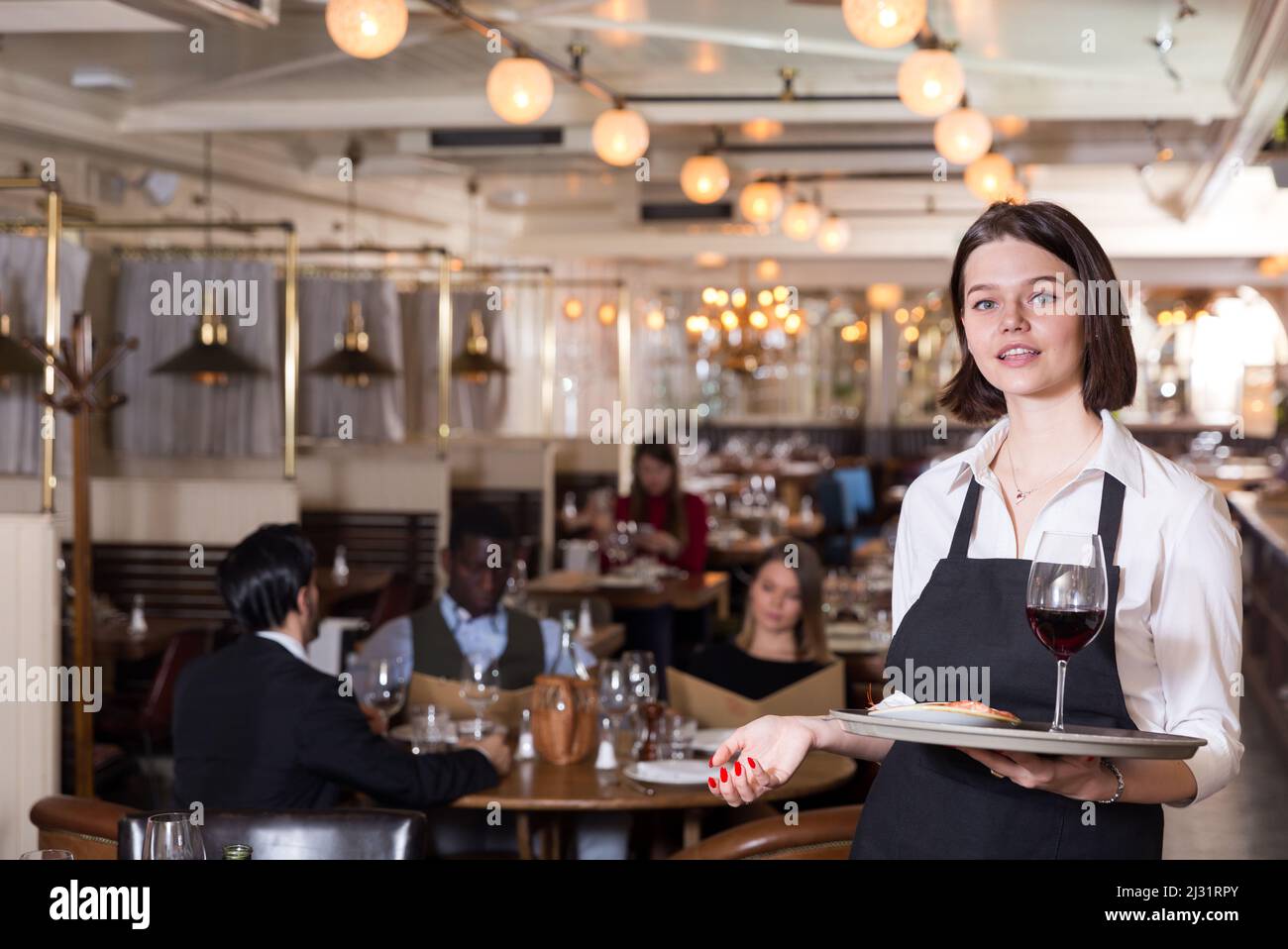 Smiling waitress with serving tray Stock Photo - Alamy