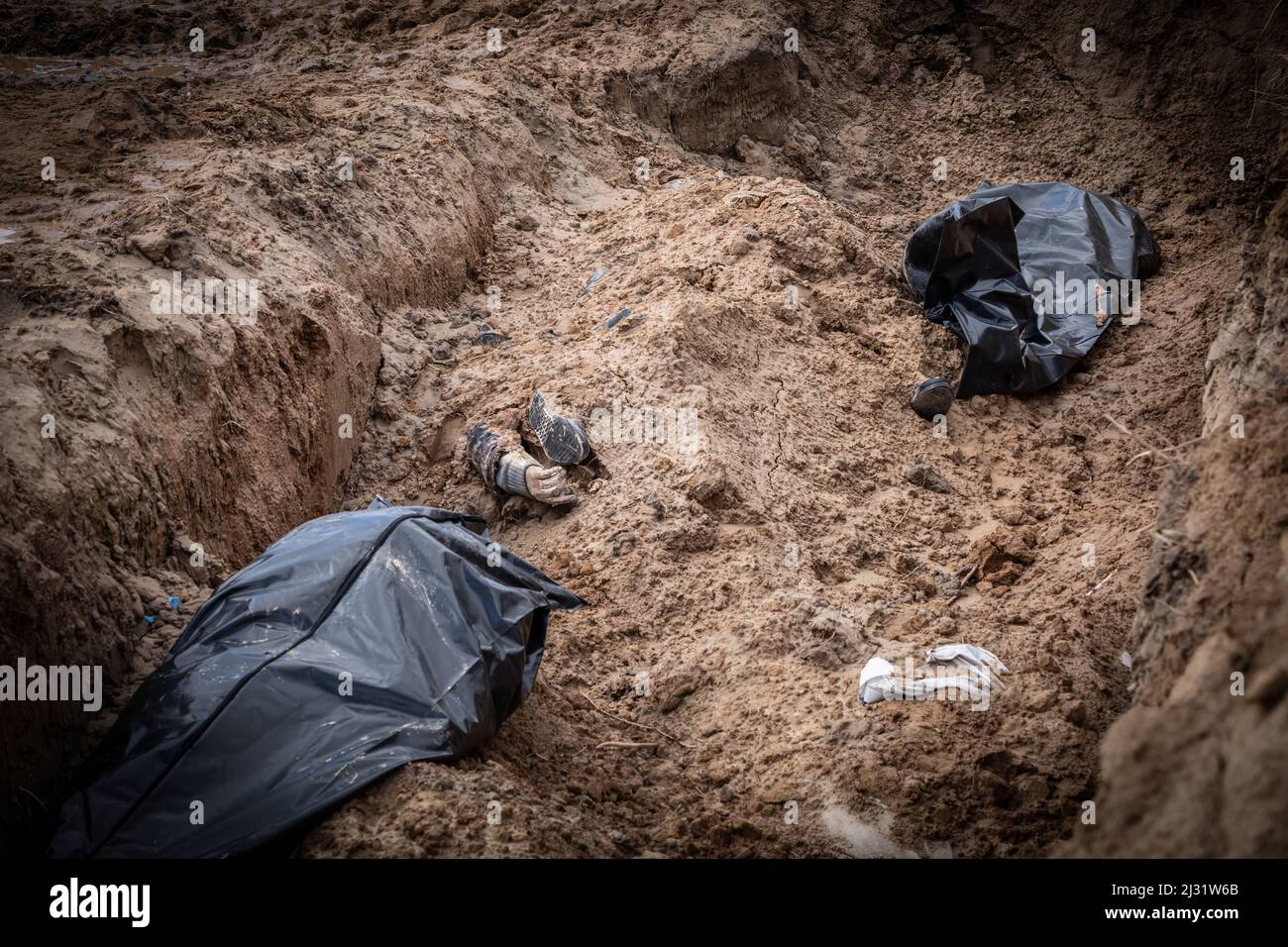 A mass grave in the town of Bucha, Ukraine, where approximately 300 ...