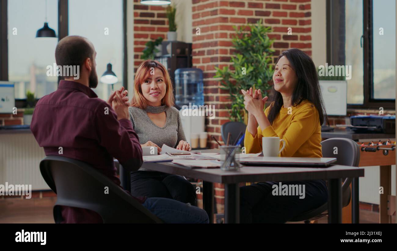 Workmates applauding and supporting motivated woman with successful ...
