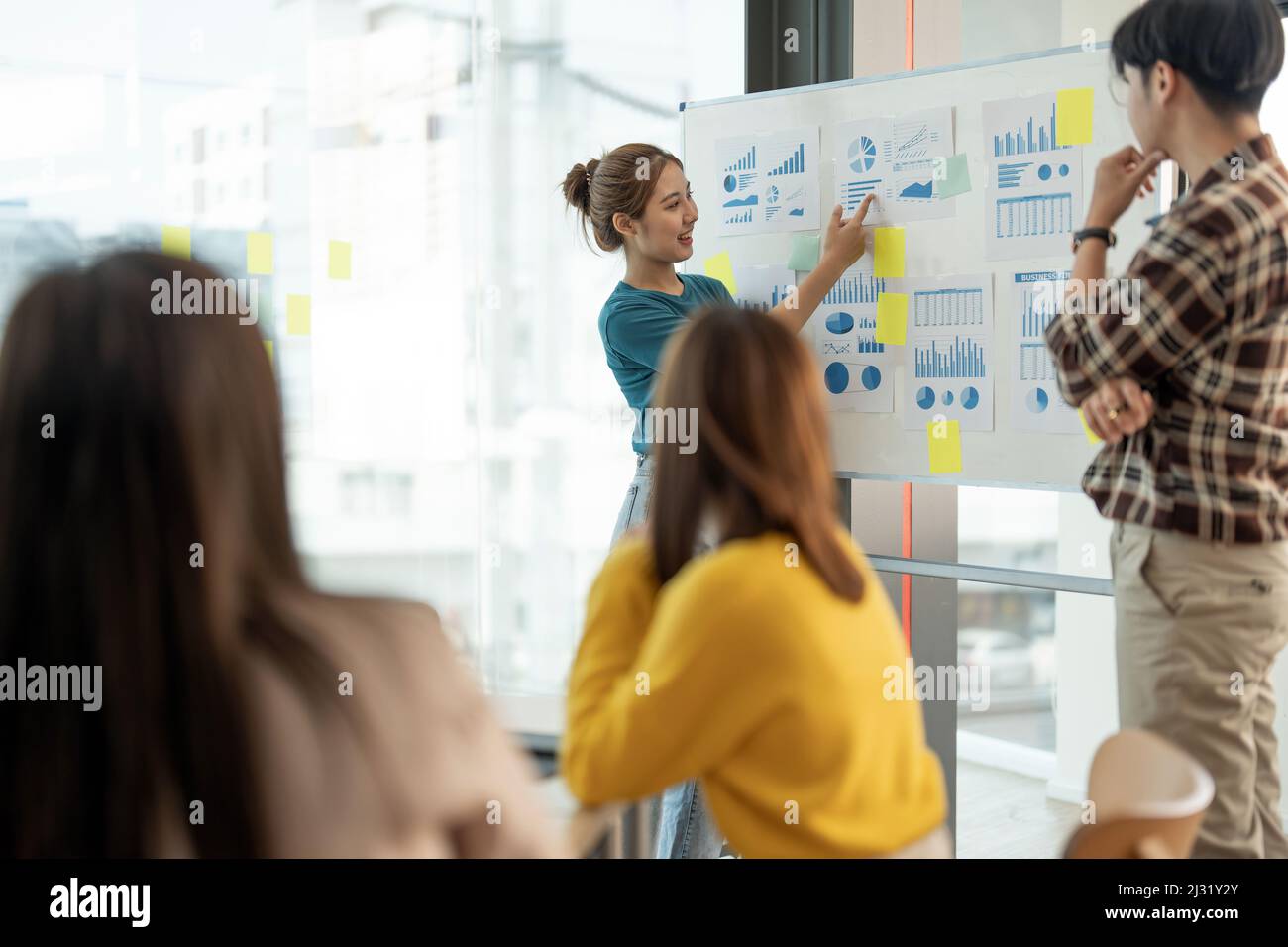 group of young creative asian people doing brainstorming meeting ...