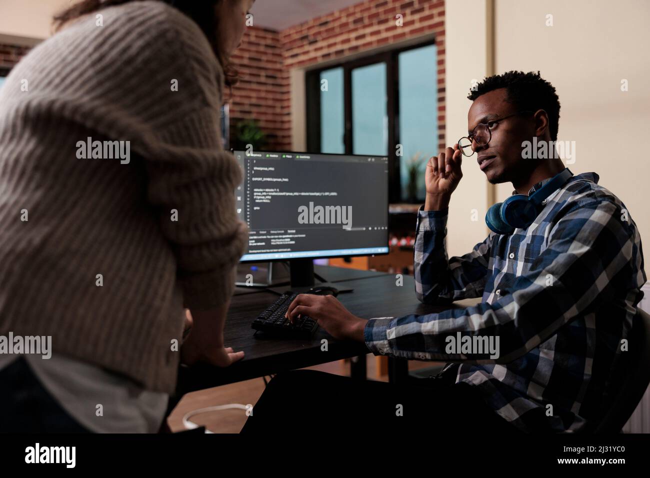 Software developers sitting at desk and developing a functional data encryption system ...