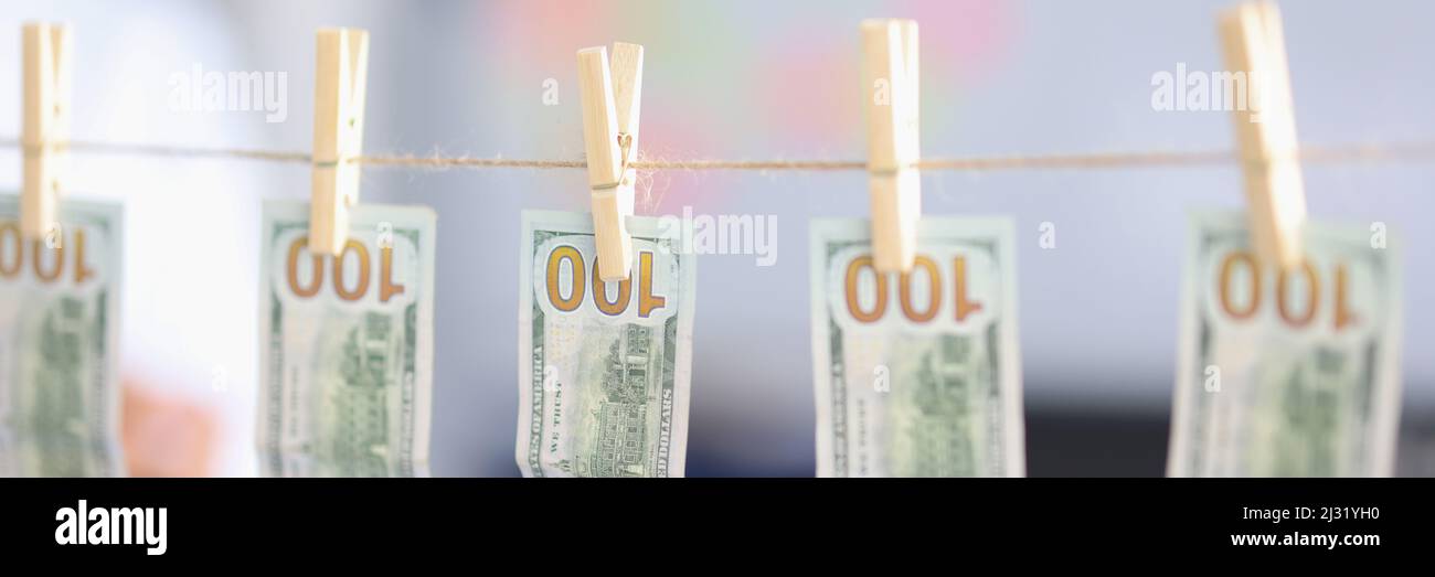 Green banknotes attached with clothespin Stock Photo - Alamy
