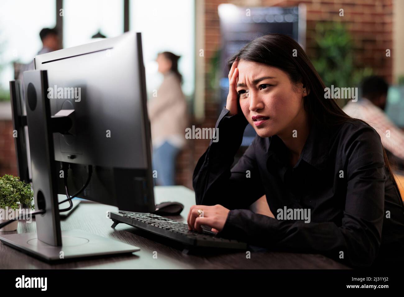 Doubtful asian computer engineer puzzled by nonfunctional security ...