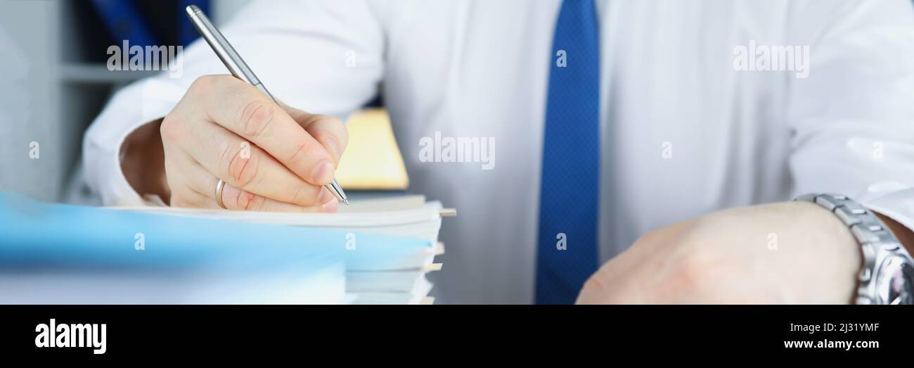 Employee in suit with stack of papers Stock Photo - Alamy
