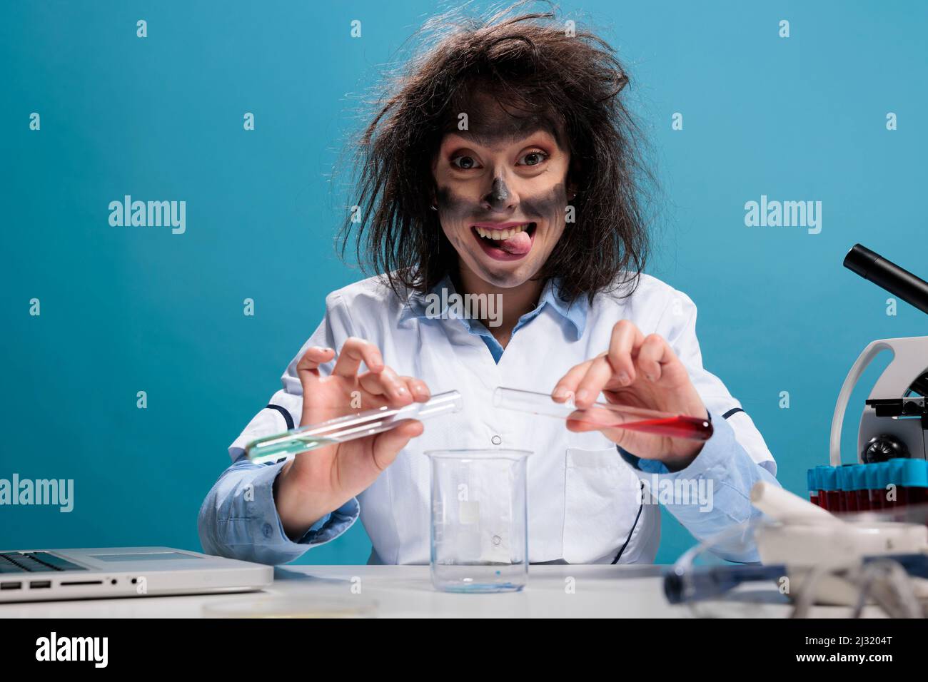 Lunatic goofy chemist with wild face expression testing new chemical ...