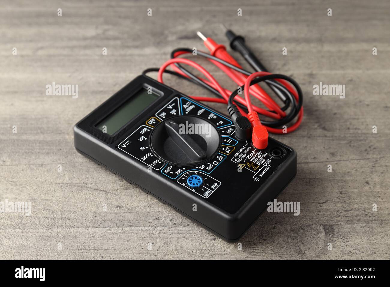 One black multimeter on gray textured background Stock Photo - Alamy