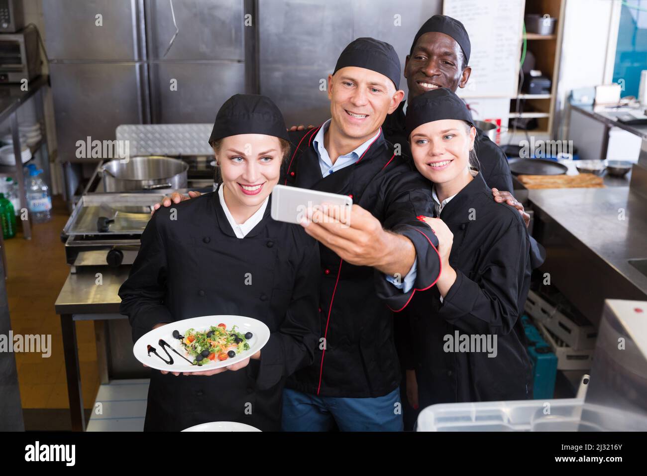 Group of chefs taking selfie in kitchen Stock Photo - Alamy