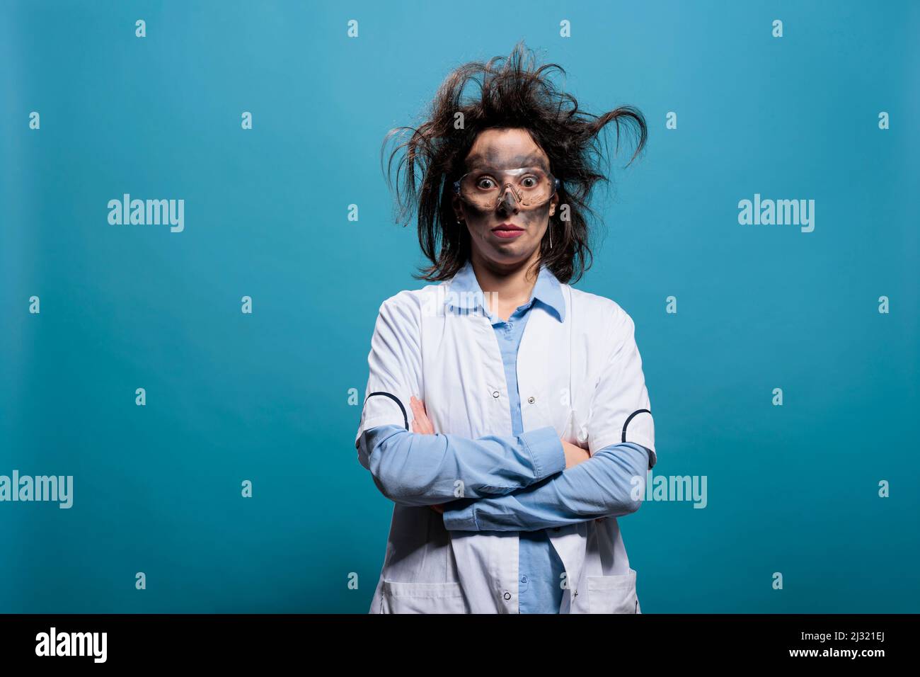 Humorous mad scientist with erratic hair and filthy face standing with ...