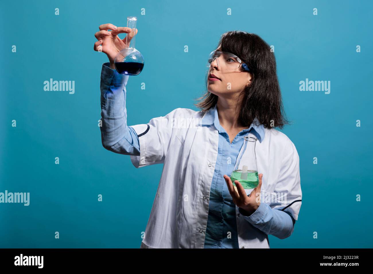 Laboratory scientist expert analyzing volumetric glass flask filled ...