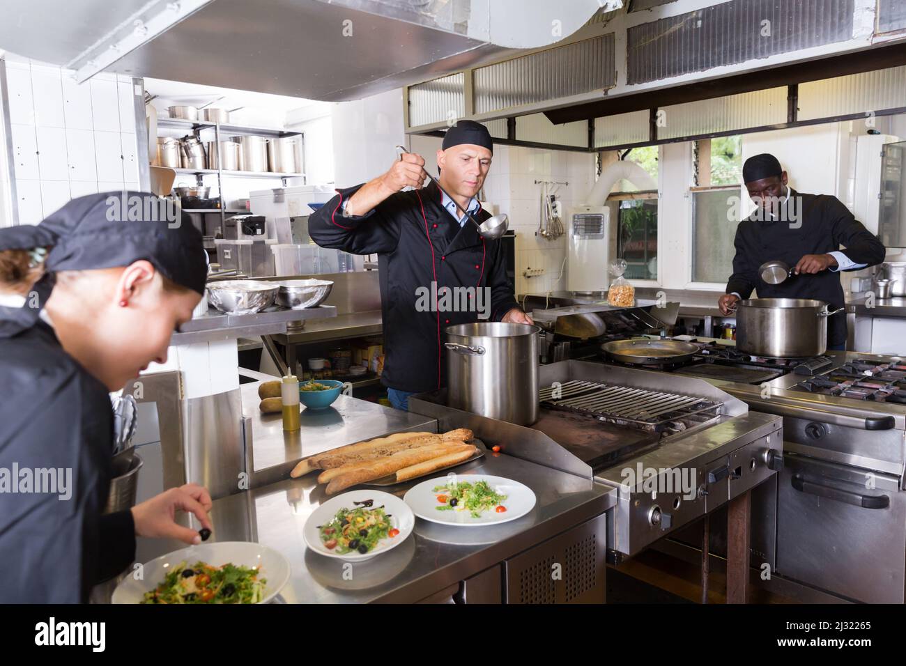 Chef checking dishes in kitchen Stock Photo - Alamy