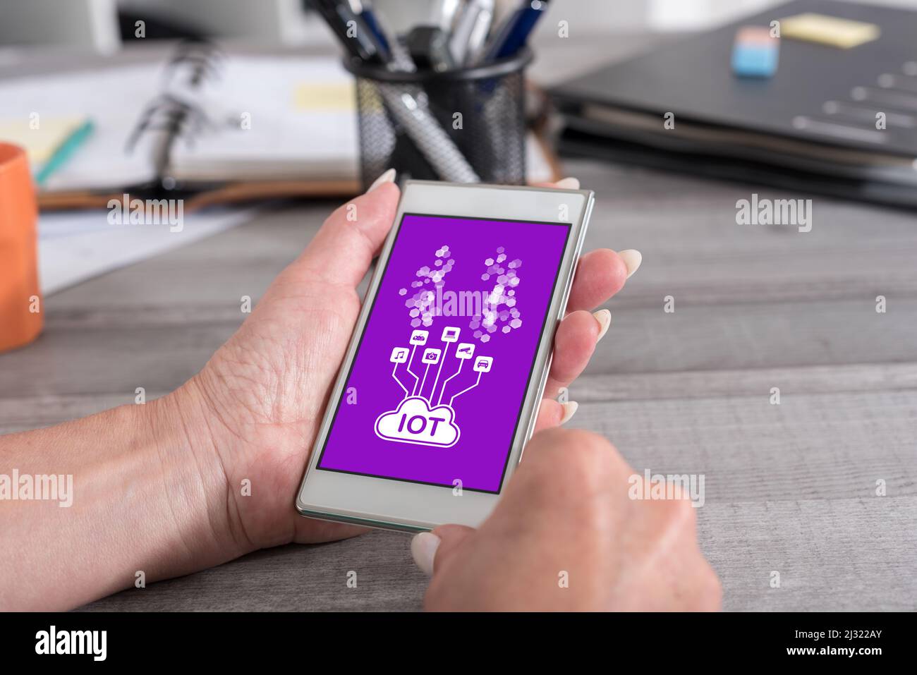 Female hand holding a smartphone with iot concept Stock Photo - Alamy