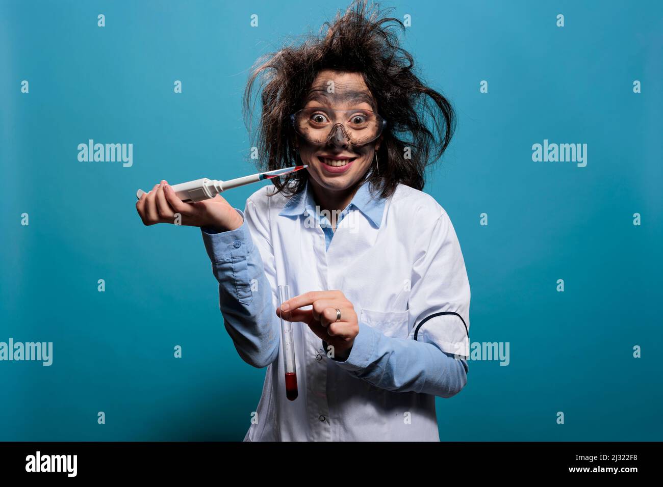 Insane lab worker grinning creepy while dripping toxic compound from ...