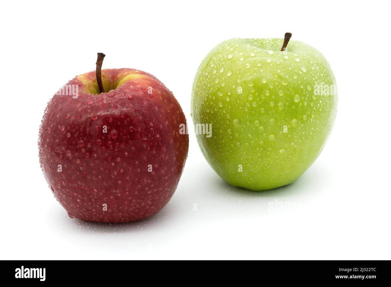 Two apples - red and green apple on white background with water drops ...