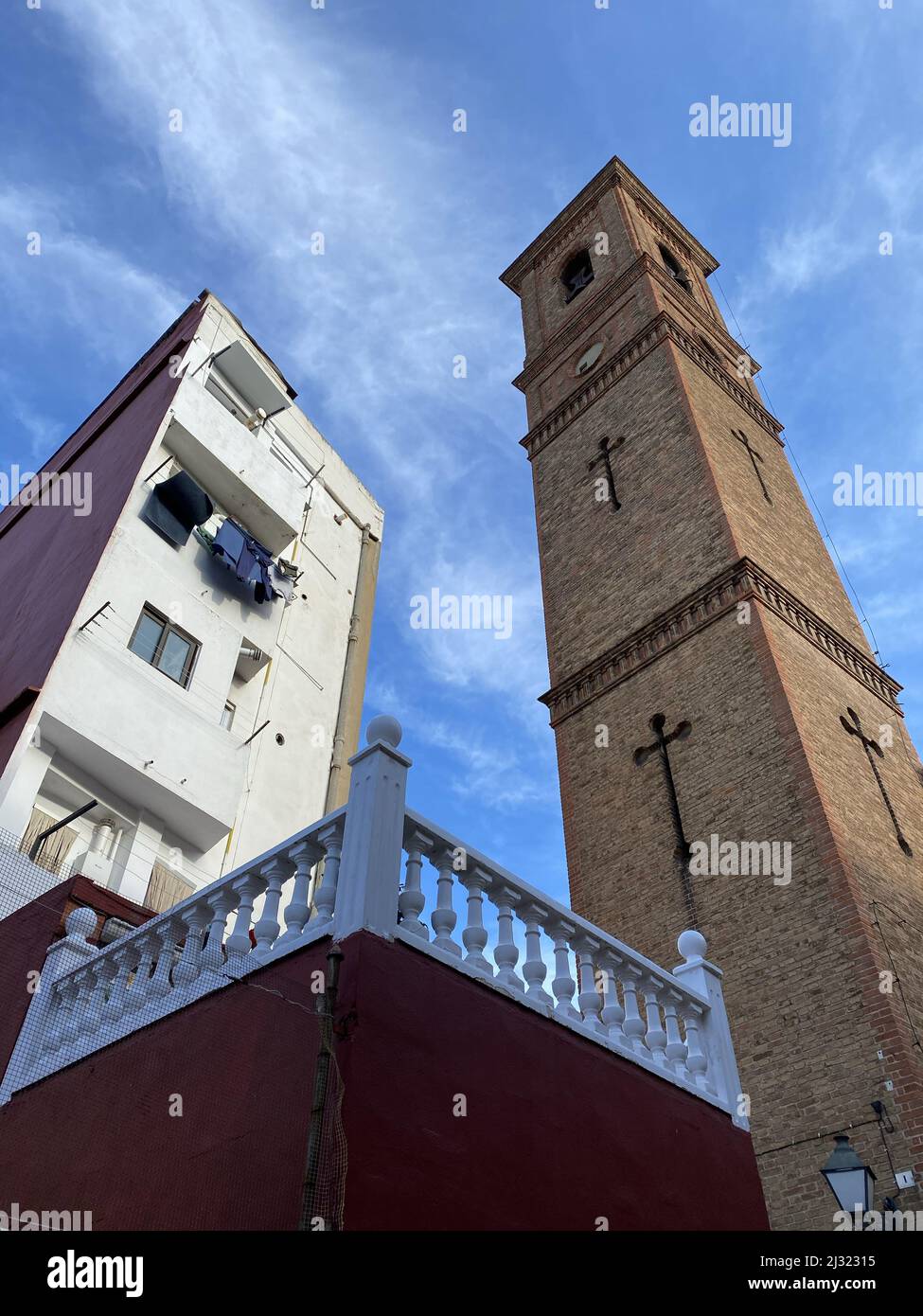 A low angle shot of a stone church tower with crosses and building ...