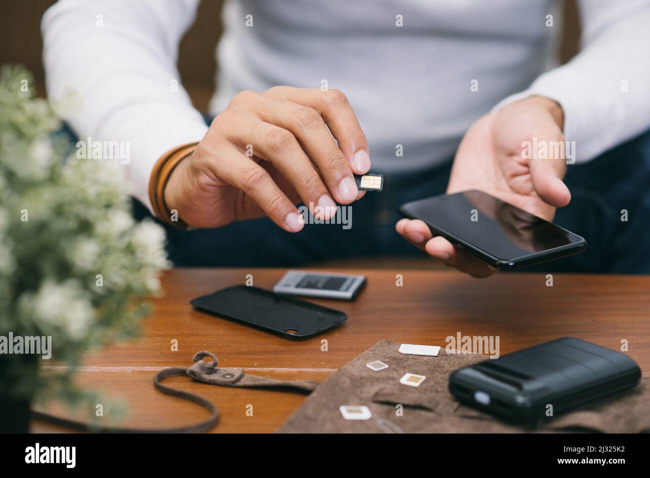 SIM card for smart phone. The man changing the SIM card Stock Photo - Alamy