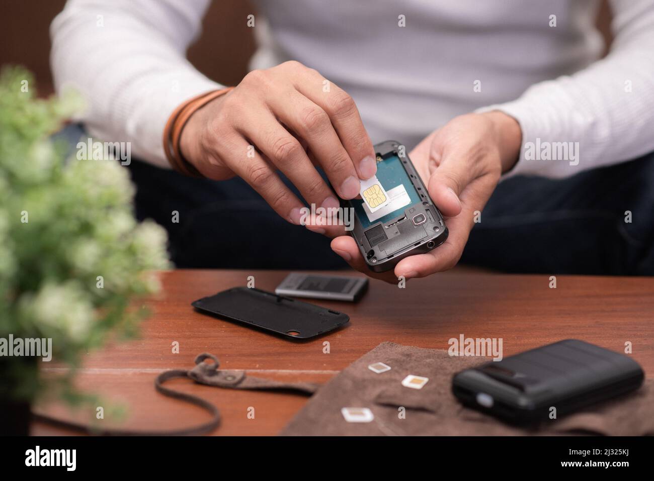 SIM card for smart phone. The man changing the SIM card Stock Photo - Alamy