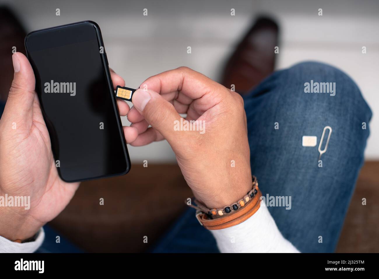 SIM card for smart phone. The man changing the SIM card Stock Photo - Alamy