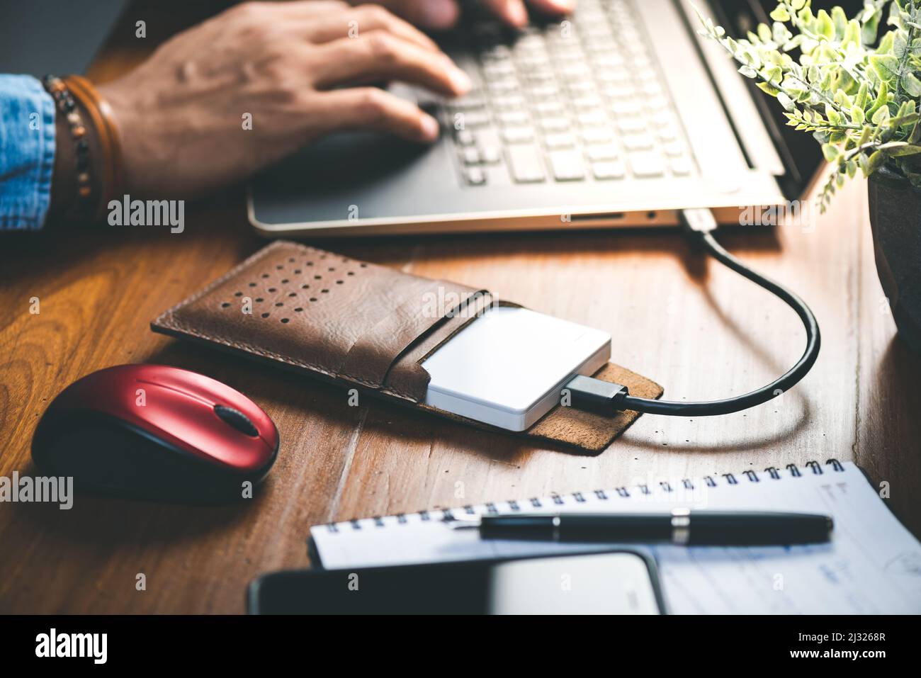 Closeup external hard drive on wooden desktop. Working with external ...
