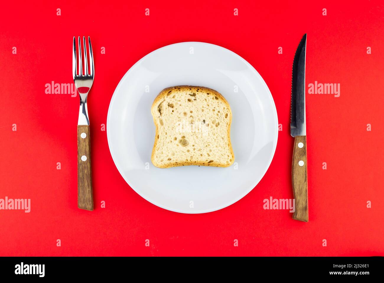 A top view of a single slice of bread for lunch (concept of being poor ...