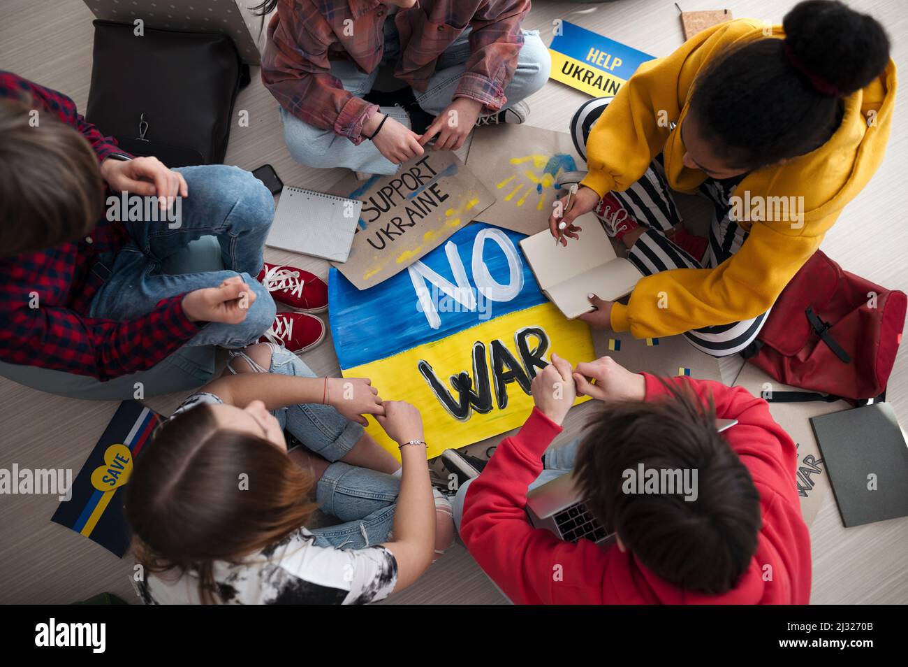 Top view of teenage students sitting at circle in classroom with ...